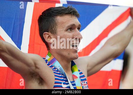 Gold medalist Jake Wightman, of Britain, poses on the podium after the ...