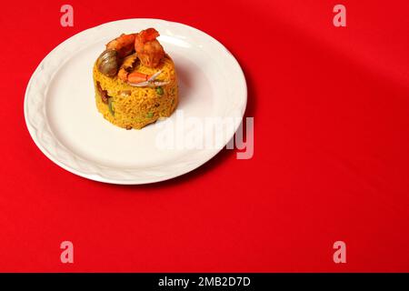 Arroz a la paella is a Spanish cuisine recipe made in a large pan with ...