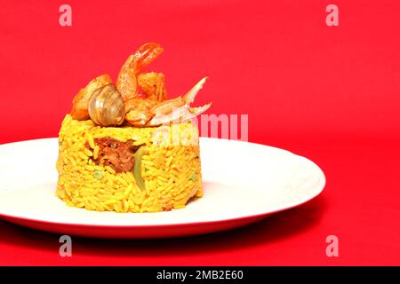Arroz a la paella is a Spanish cuisine recipe made in a large pan with ...
