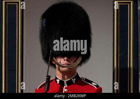 A guard wearing a traditional bearskin stands guard outside the Jewel ...