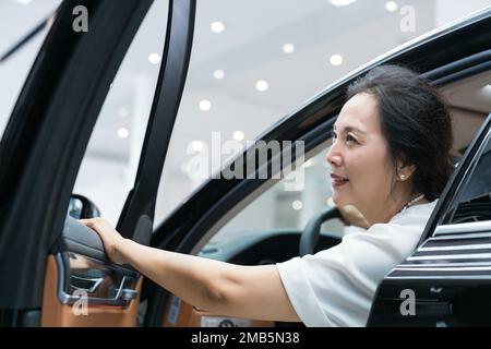 Elderly woman test drive cars Stock Photo - Alamy