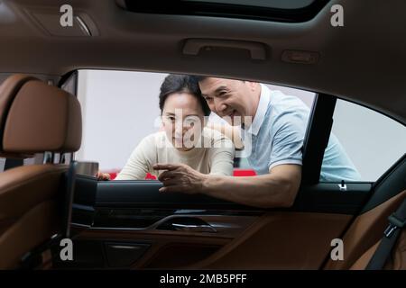 Elderly couples test drive cars Stock Photo - Alamy