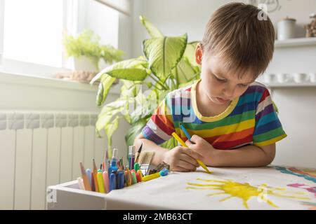Confident cute male kid art drawing multicolored rainbow arch use ...