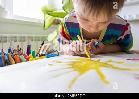Confident cute male kid art drawing multicolored rainbow arch use ...