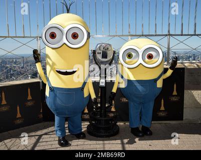 Two Minion characters pose on the 86th floor observatory deck at the ...