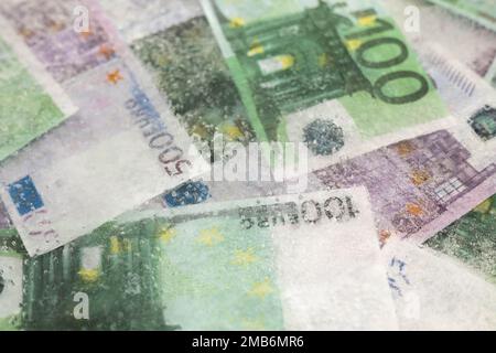 Blurred photo of one hundred and five hundred euros are defrosted in ...