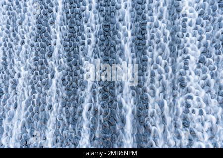 Artificial waterfall with water jets, modern stone structure, beautiful ...