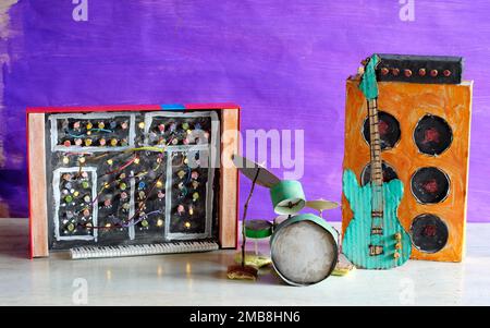 Grungy cardboard models of synthesizer,drum kit,guitar,amplifier and ...