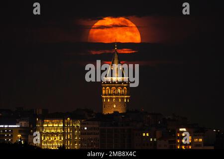 A supermoon rises behind the Galata Tower in Istanbul, Turkey, Tuesday ...