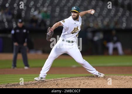 Oakland Athletics relief pitcher Sam Moll (60) throws to home plate ...