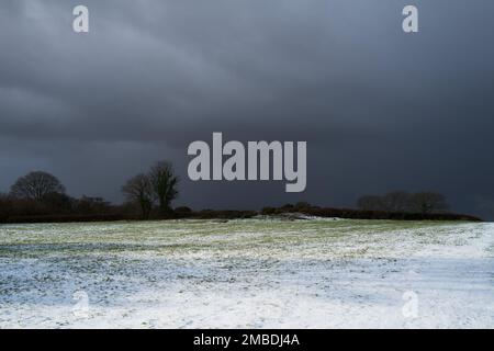 An approaching snow storm in fields near the village of Tregarth in ...