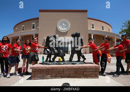 Students from Doña Ana Elementary School pose for a photo with a statue ...