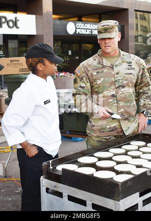 Col. Damon Wells, commander of 4th Infantry Division Artillery, hands over the battalion colors ...