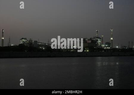 A thermal power station of Torrent Power Limited is seen behind as a ...