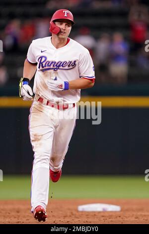 Texas Rangers' Corey Seager rounds the bases after hitting a home run during a baseball game ...