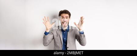 Businessman scream and shake hands in panic, look alarmed and anxious ...