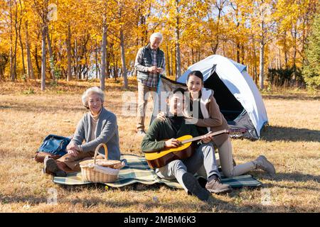 Happy family autumn camping out for a picnic Stock Photo - Alamy