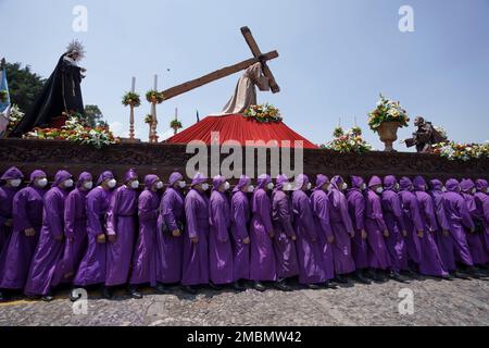 "Cucuruchos" carry a statue of Jesus Christ on a religious float during ...