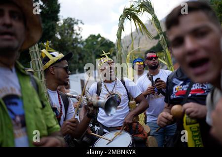 Members of the Palmeros de Chacao brotherhood, chant and sing, as they ...
