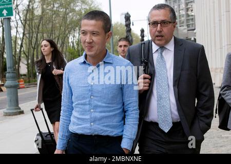 Roger Ng, center, a former Goldman Sachs banker, leaves federal court ...