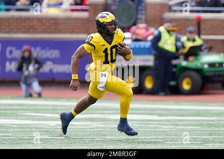 Michigan quarterback Alex Orji rushes during an NCAA college football ...