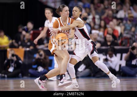 Texas guard Shay Holle, left, drives around Louisville guard Hailey Van ...
