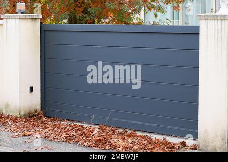 Aluminum gray metal sliding gate of suburb house Stock Photo - Alamy