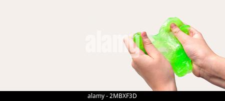 Hand Playing with textured slime on white background. Teen hand holding ...