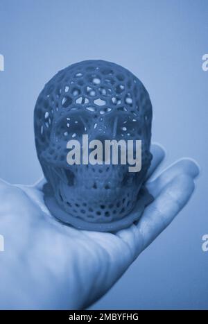 Prototype of human skull printed on 3D printer from molten purple ...