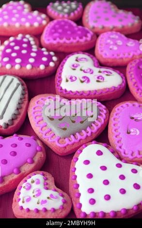 Violet and white romantic cookies on a gray wooden background with copy ...