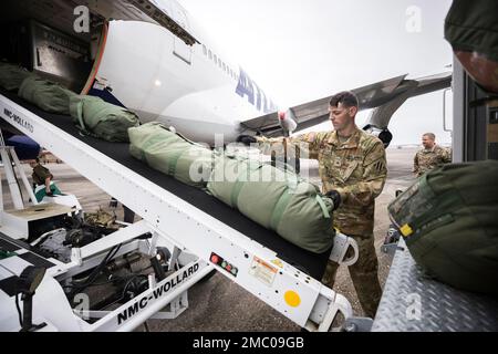 A solder with the U.S. Army's 3rd Infantry Division loads the cargo ...