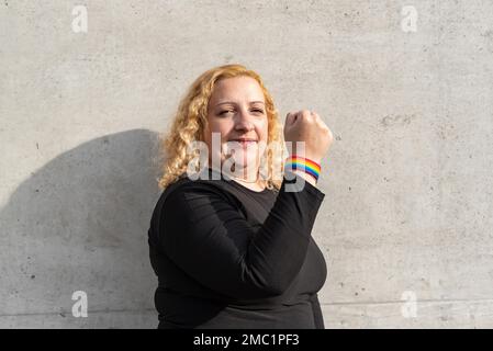 LGBT-Frau, die ein LGBTQ-Regenbogenarmband traegt, Konzept des ...