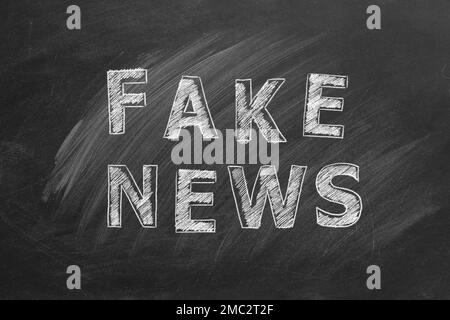 The word PROPAGANDA written in chalk on a blackboard. Information and ...