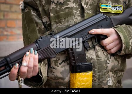 A woman holds a Kalashnikov assault rifle during the Spasskaya Tower ...