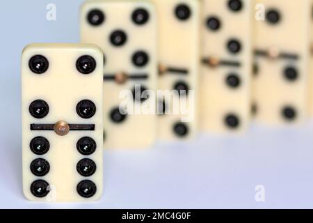 Several dominoes standing one behind the other Stock Photo - Alamy