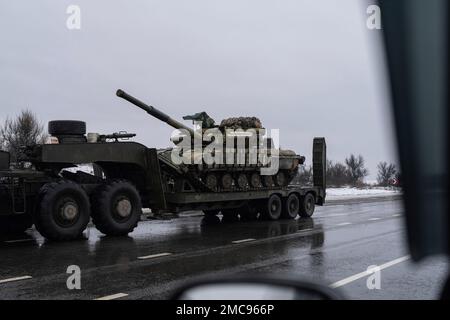 A military truck transports a platform with Ukrainian self-propelled ...