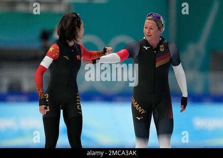 Ahenaer Adake of China, left, and Claudia Pechstein of Germany, greet ...