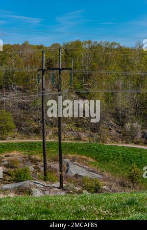 High voltage power lines going through a park outside a city Stock ...