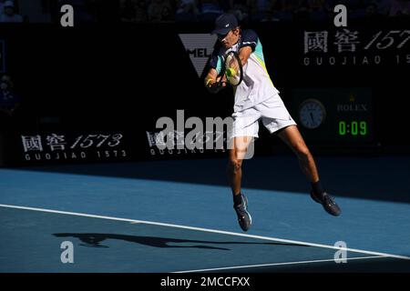 Alex de Minaur of Australia makes a backhand return to Jannik Sinner of Italy during their ...
