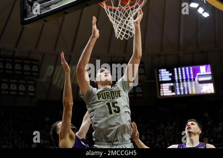 Purdue center Zach Edey (15) dunks the ball ahead of Butler forward Ty ...