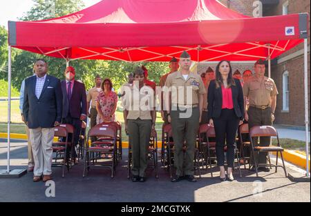 U.S. Marines, DoD civilians, retirees, and guests take part in a ribbon ...