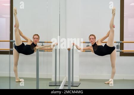 Young ballerina practicing ballet pose in a ballet school Stock Photo ...