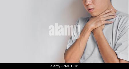 Tightness at the neck of Asian, Myanmar man. Concept of sore throat ...