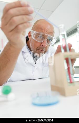 Scientist in uniform doing tests in laboratory Stock Photo - Alamy