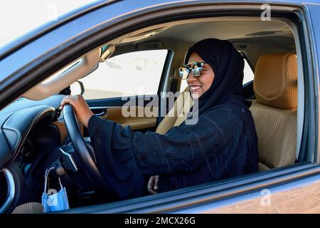 Veiled woman driving a car, AlUla, Medina Province, Saudi Arabia ...