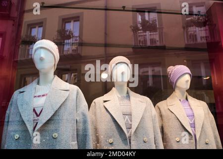 Group of three dummies in a fashion store with as background a ...