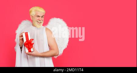 Bearded man in angelic wings with red paper heart. Valentines day card ...