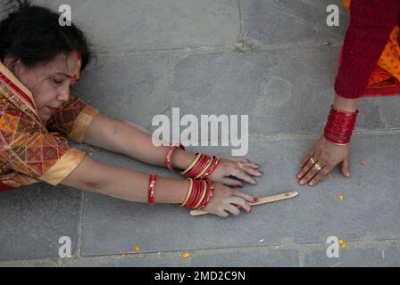 Nepalese Hindu devotee prostrate on the ground outside a temple as a ...