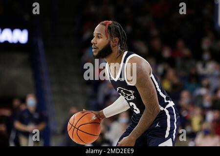 Dixie State guard Cameron Gooden, right, controls the ball while ...