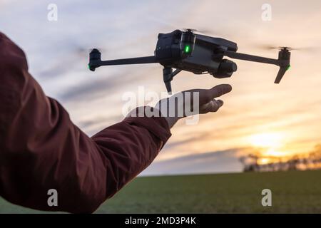Drone Pilot Launching Drone from Hand at Sunset Stock Photo - Alamy